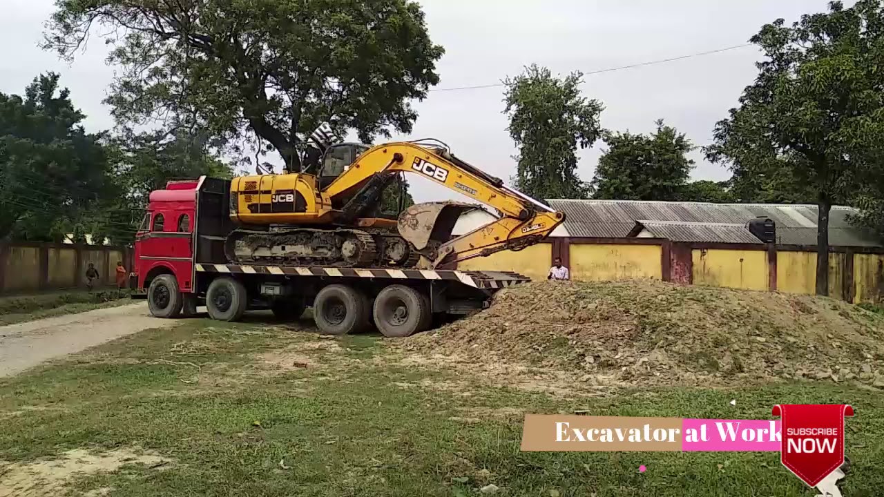 JCB Backhoe Dozer Unloading from a Truck after Loading a Tractor - YouTube