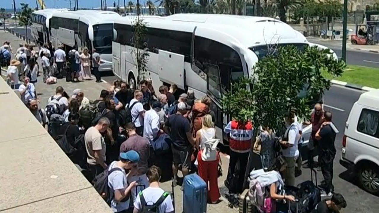 Foreign passport holders board buses in Tel Aviv for evacuation out of ...