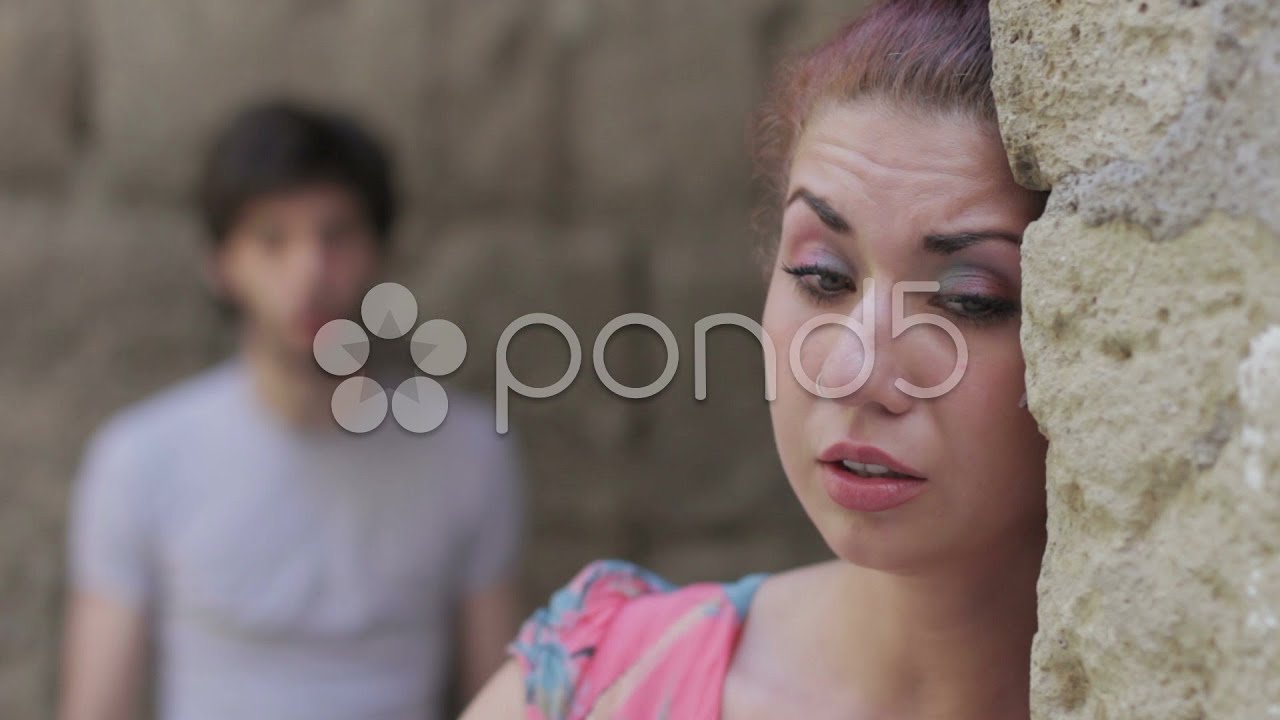 Relationship difficulties, couple fighting outdoors, the woman is ...