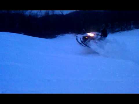 Snowmobile hitting snow drift - YouTube