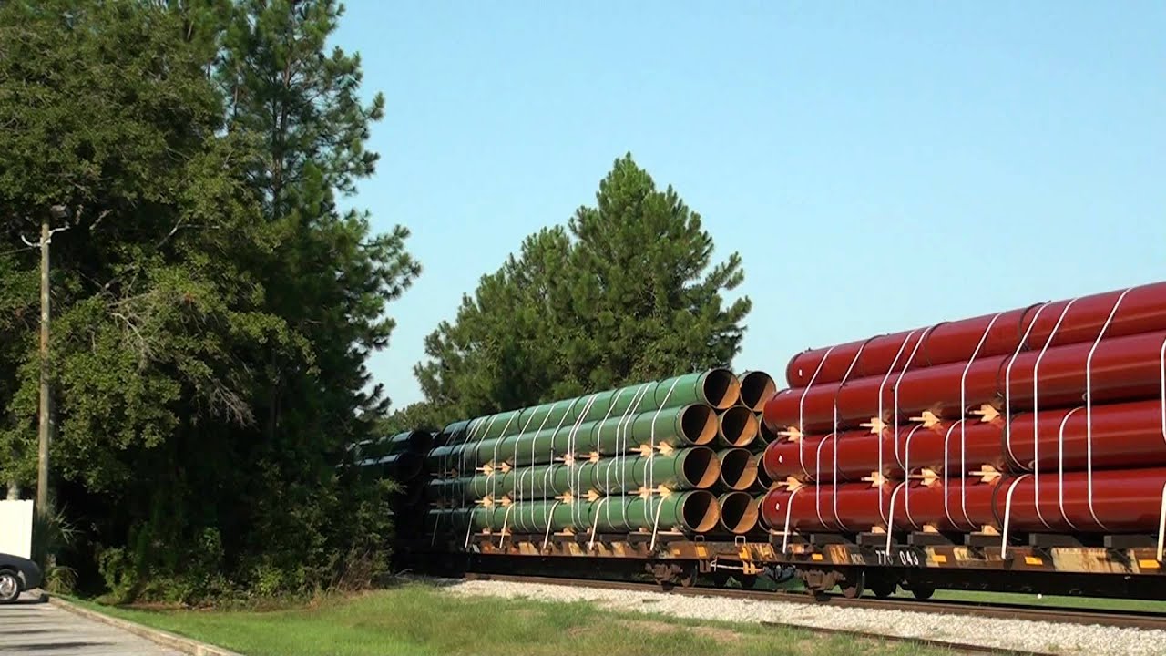 Bayline railroad GP38-2 works hard in hauling loaded pipe train - YouTube
