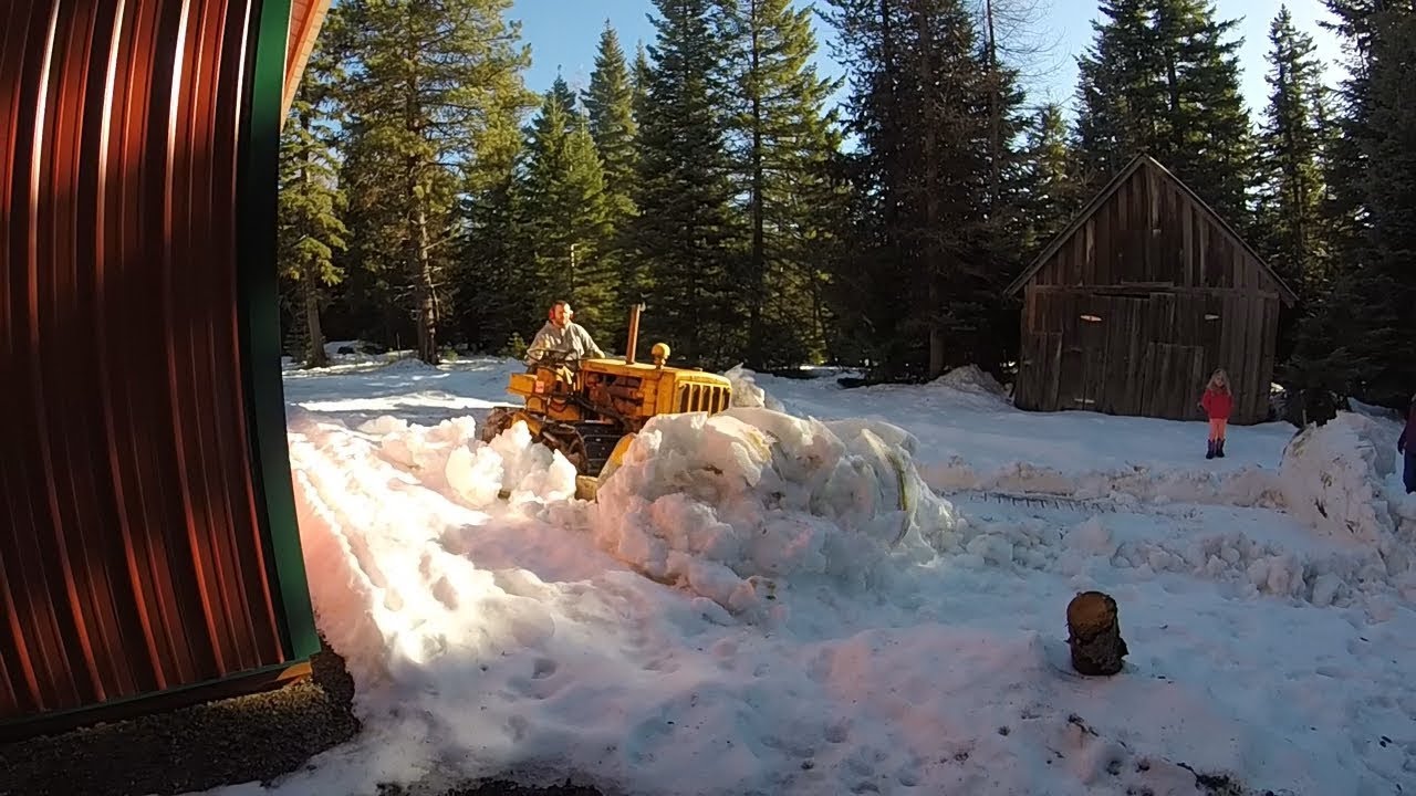 Plowing snow bank for the kids - YouTube