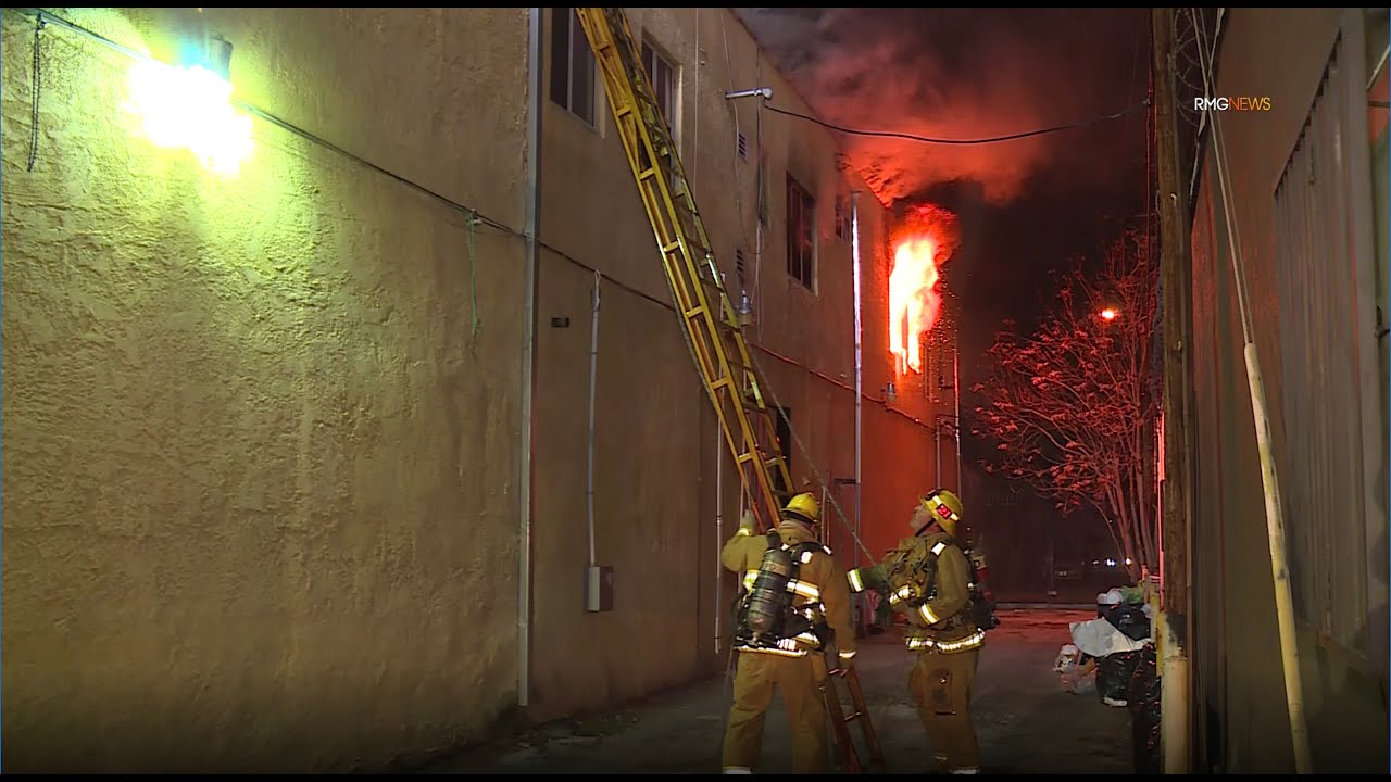 Apartment Complex with Heavy Fire- Dramatic scenes of LAPD running in ...