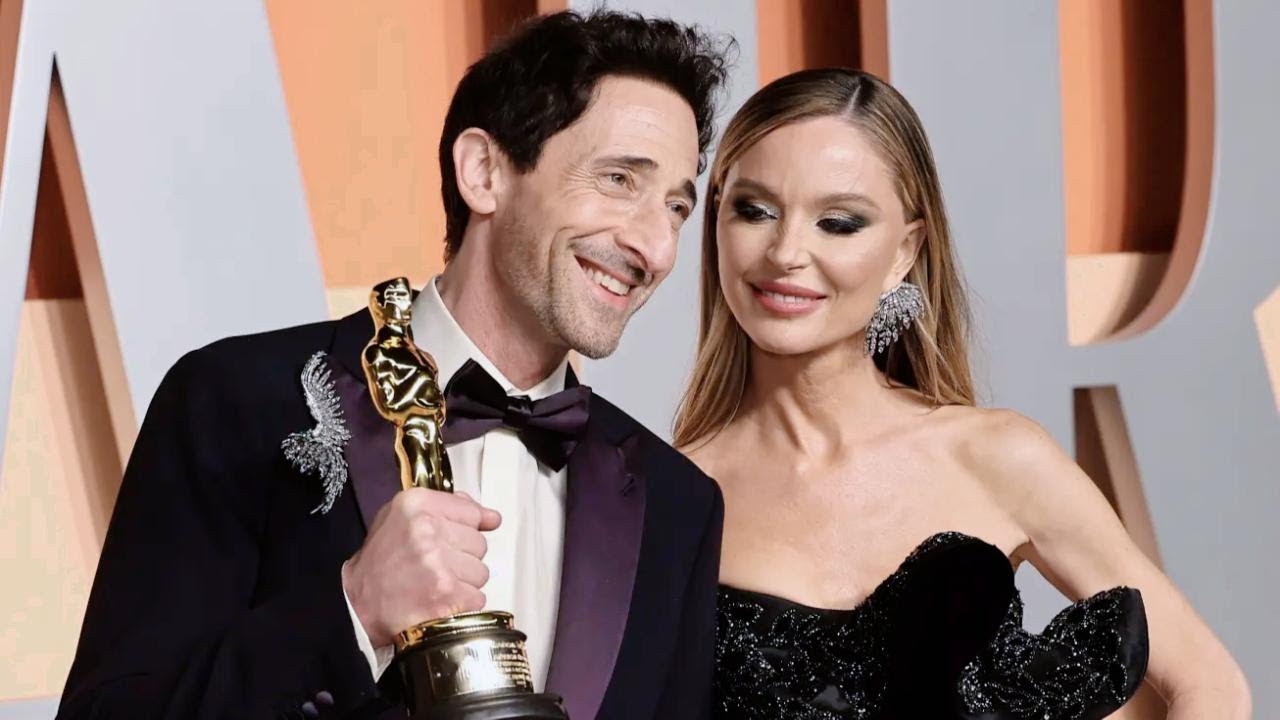Watch Adrien Brody spit out gum, toss it to girlfriend Georgina Chapman ...