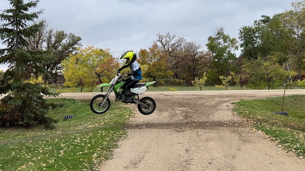 Two Kawasaki KX65 jumping driveway! - YouTube