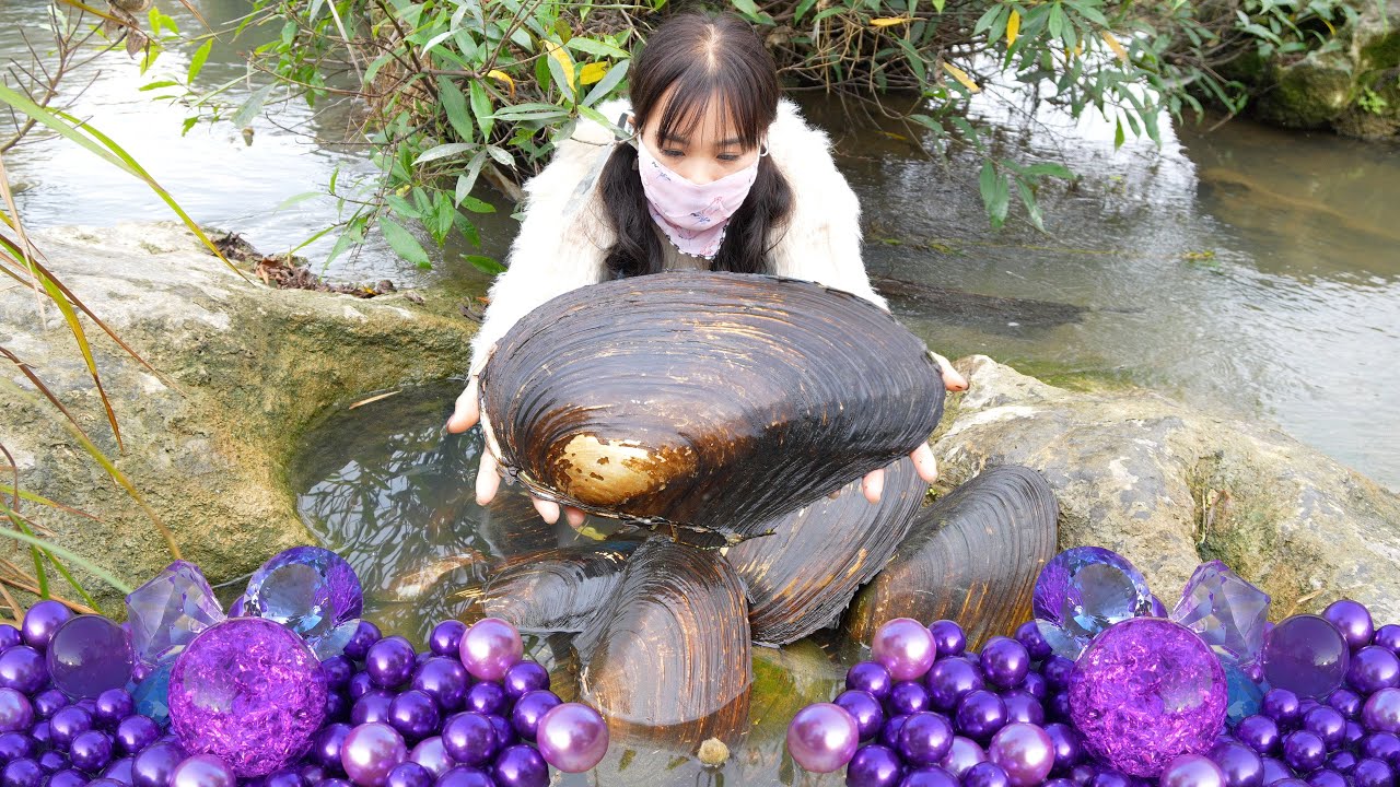 A girl explores and discovers a giant river clam, which contains ...
