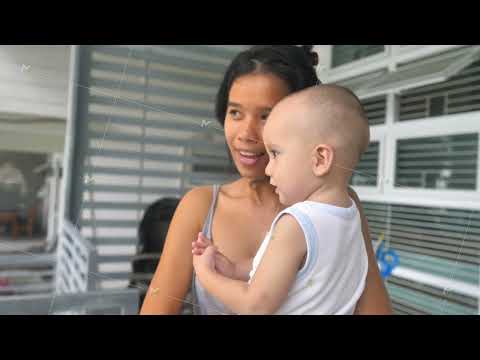 Cheerful Asian mother with mixed race baby dancing, playing and kissing her boy.