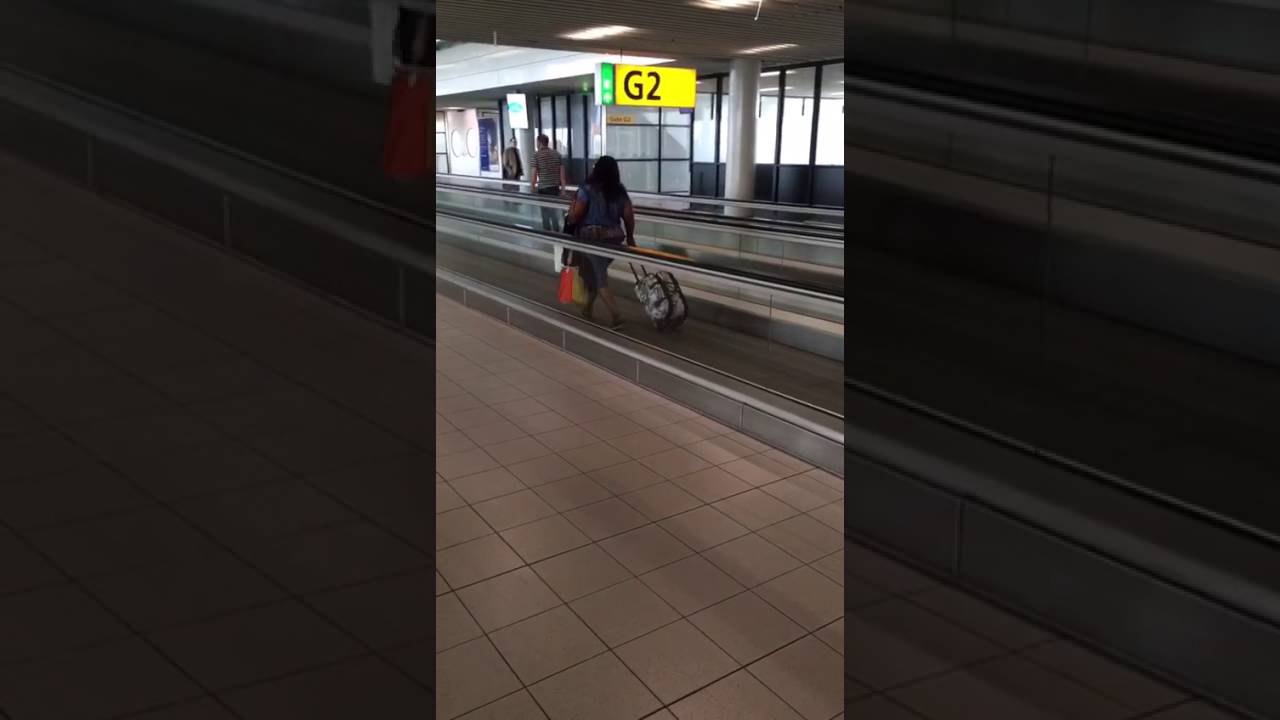 Lady walking wrong way on moving walk way - YouTube