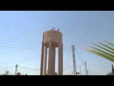 26 7 Amouda Al Hasakah أوغاريت عامودا الحسكة   رفع العلم الكوردي وعلم الثورة في سماء  المدينة