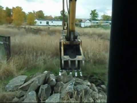 Placing Rip Rap Rock using Drott 50 excavator with a thumb - YouTube