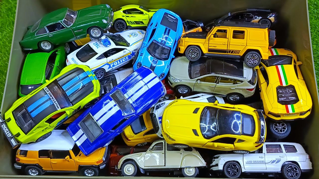 Box full of various miniature cars Jaguar, Peugeot, Renault, Hyundai ...