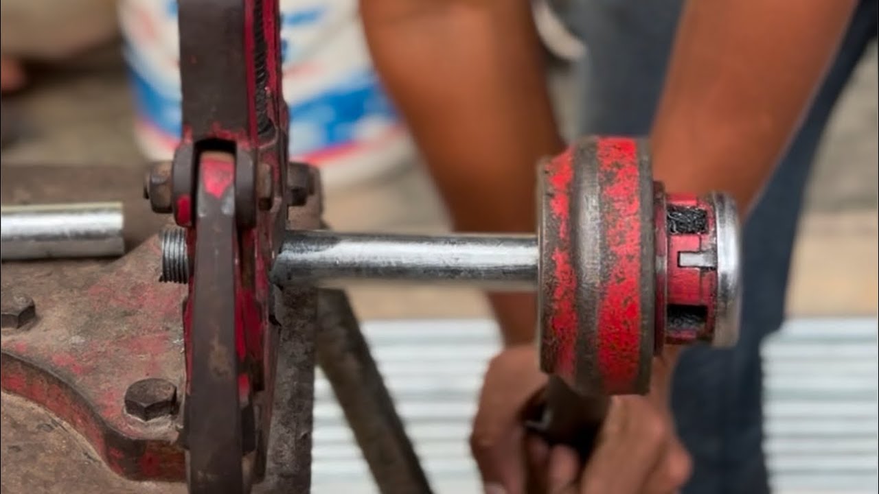 A Skilled Worker Operating a Metal Press Machine to press GI pipe ...