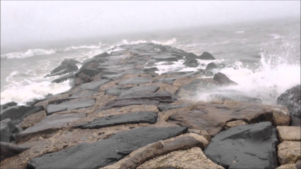 Waves breaking over the Longport Jetty - YouTube