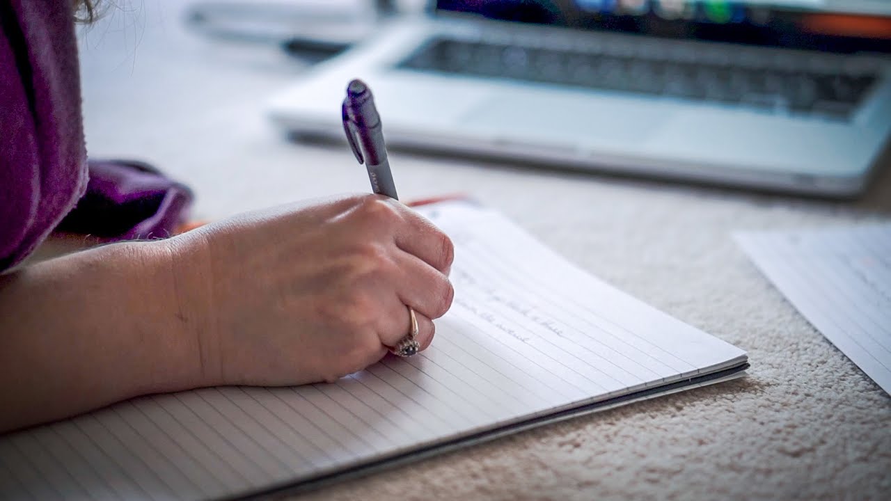 Girl Writing with MacBook in Background - Stock Footage - YouTube