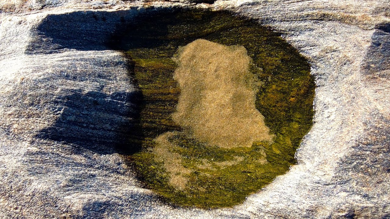 10 Minutes Relax - Puddle of sea water with sand on a rock on the beach ...