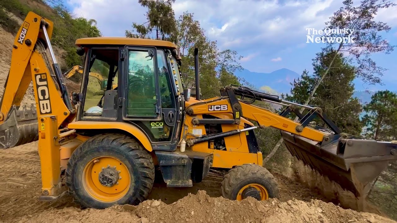 Road Projects | JCB backhoe pushing down mud to create a wide road ...