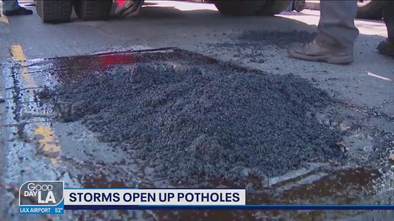 Storms open up potholes - YouTube