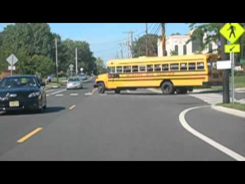 Driver passing school bus with flashing red lights