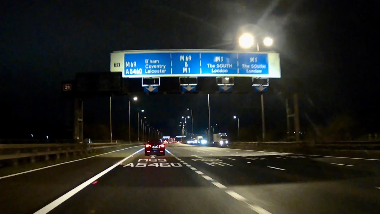 Driving at night along the M1 motorway southbound between J21A & J21 ...