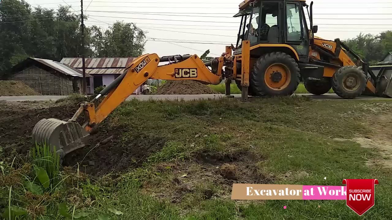 Busting the Mud - JCB Backhoe Digging Roadside for Road Construction ...