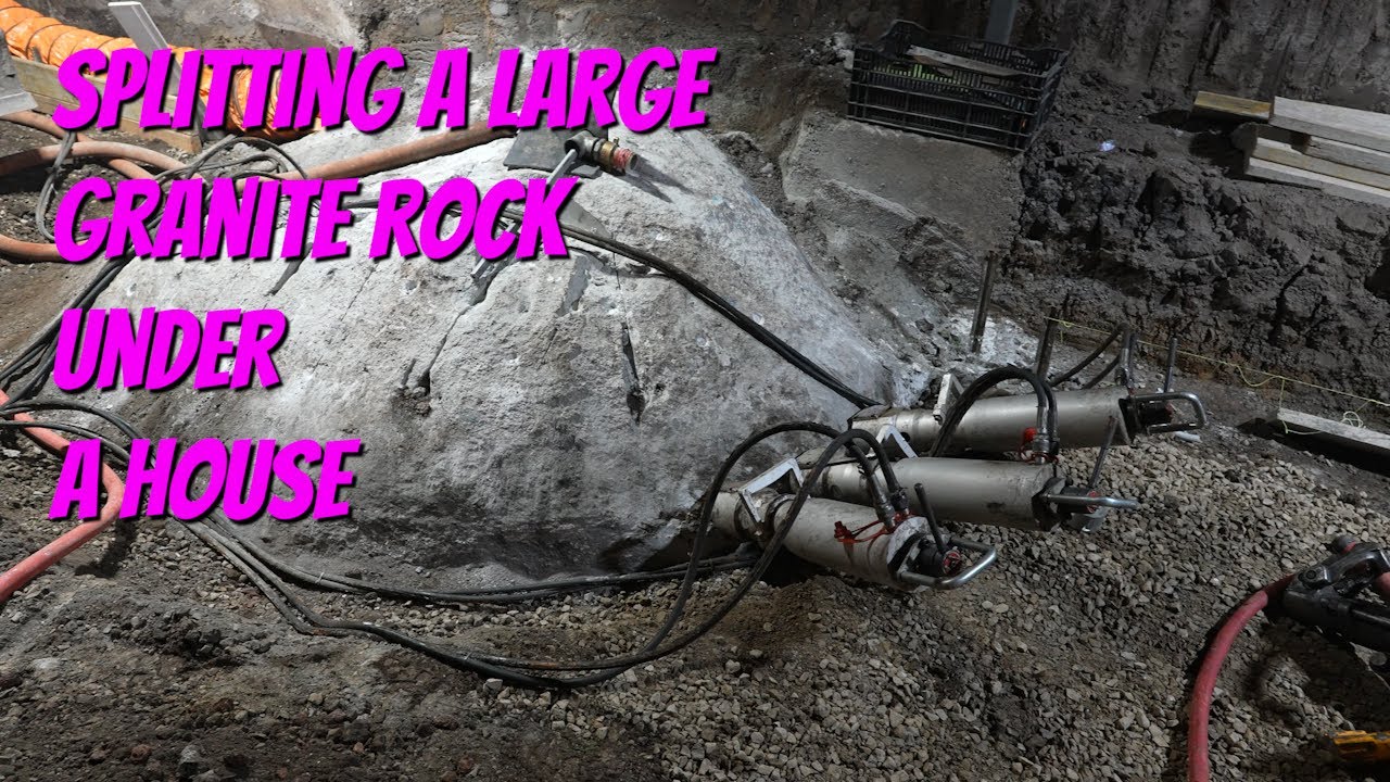 Splitting a large granite rock under a house - YouTube