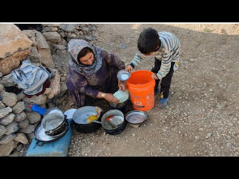 Nomadic life in Iran: Nomadic children help their mother to wash the ...
