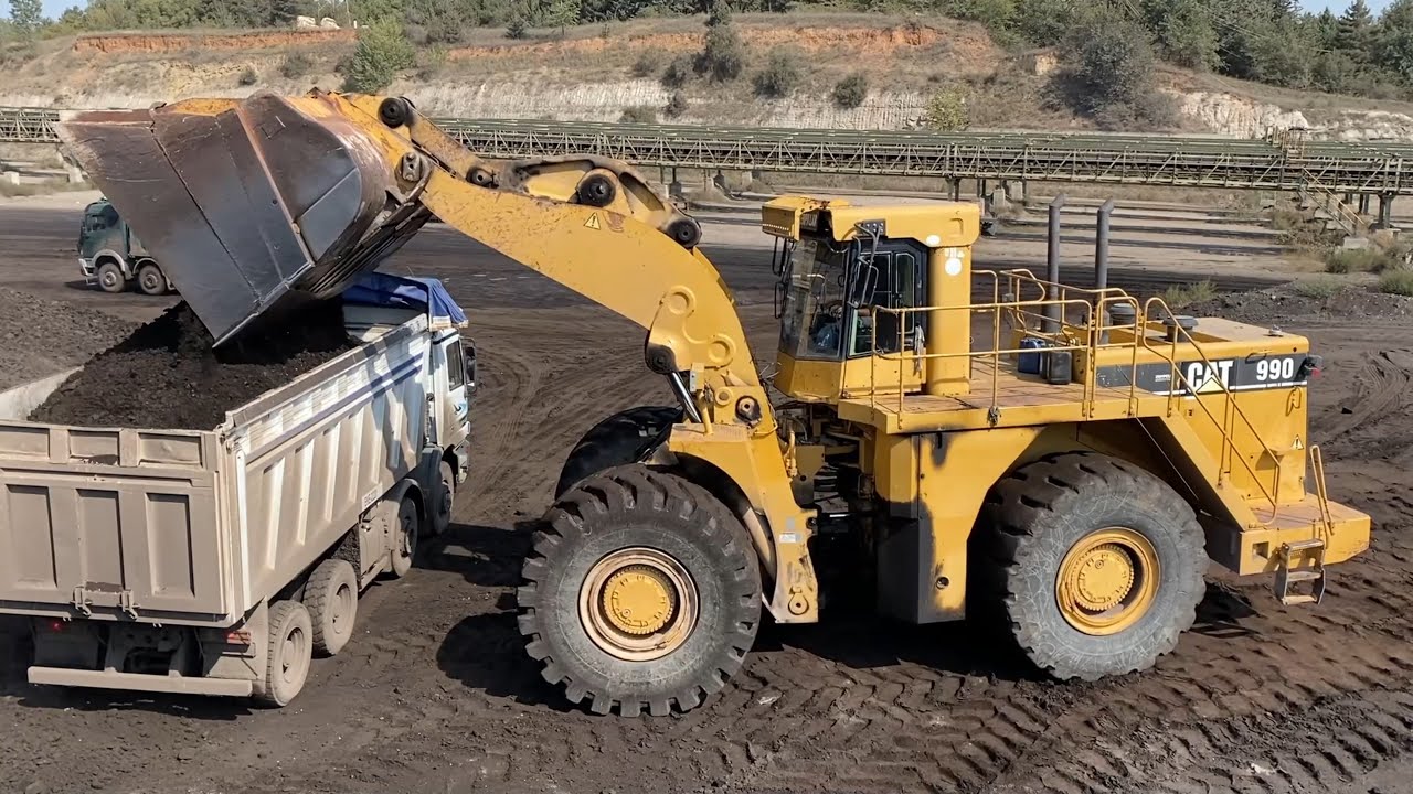 Caterpillar 990 Wheel Loader Loading Mercedes And MAN Trucks With Coal ...
