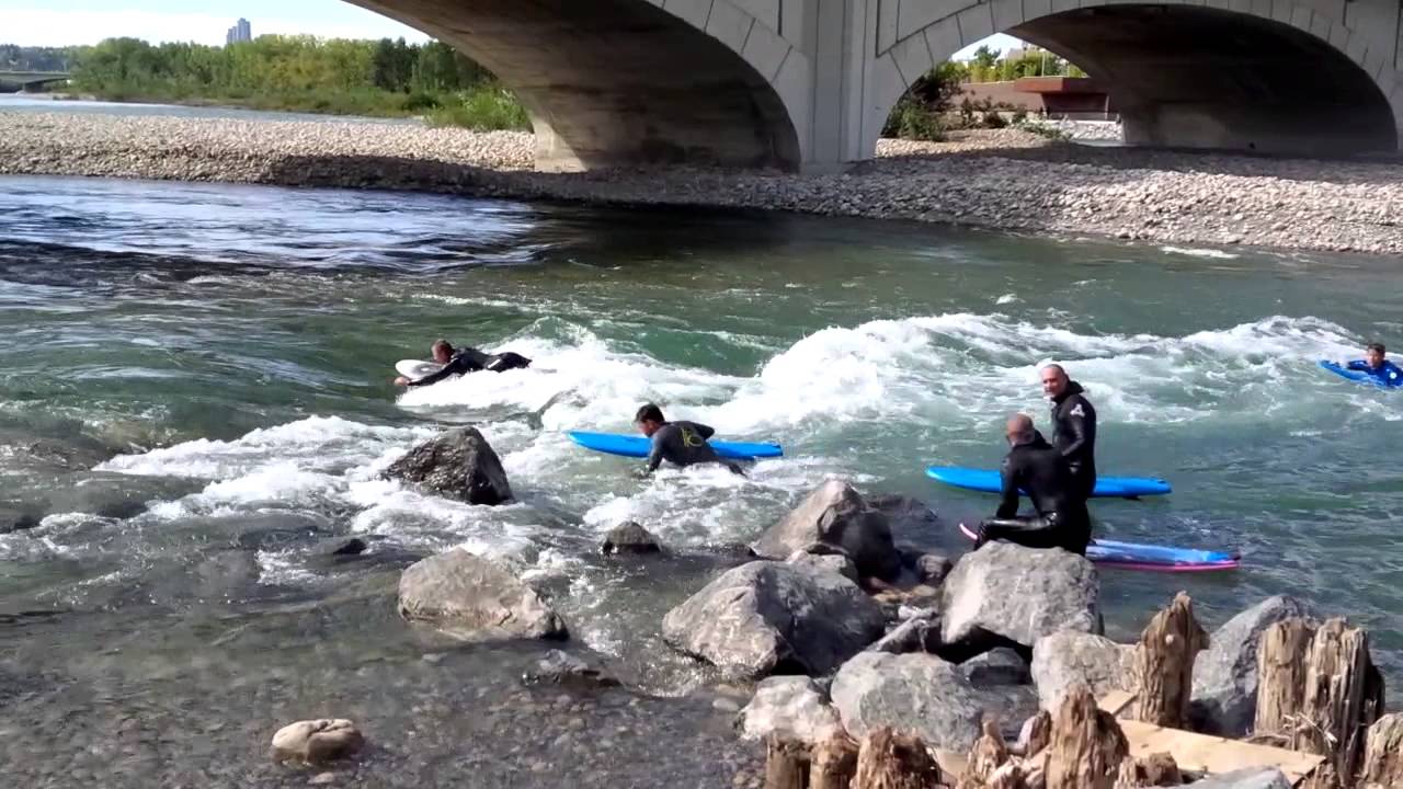 "Boys" river surfing the Bow, by the 10th street bridge in Calgary ...