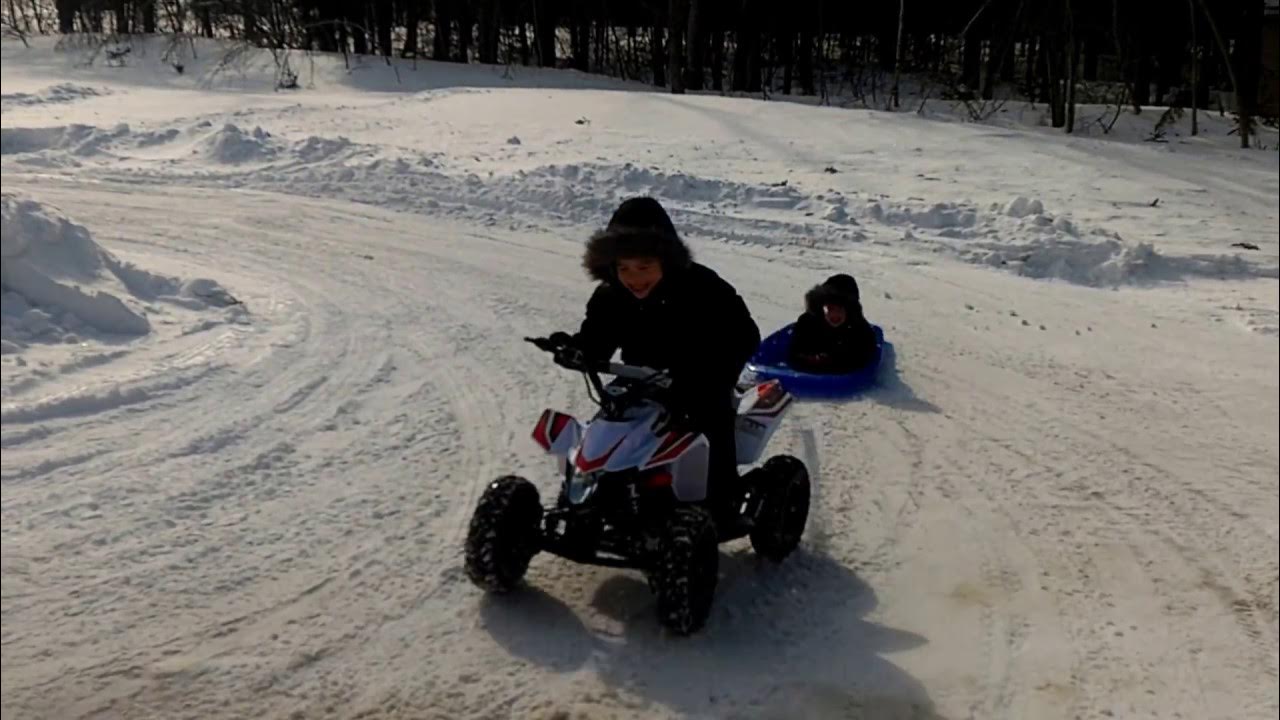 Twins pulling a sled with their ATV 4 wheeler - YouTube