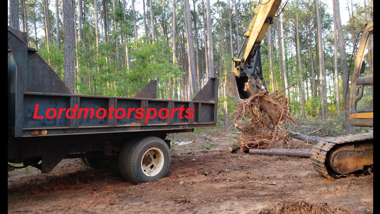 Loading trees with excavator - YouTube