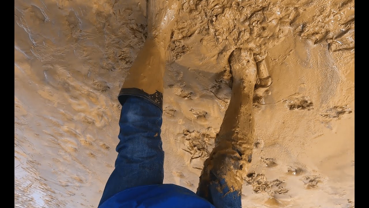 Jeans, rainwear and rubberboots in deep quarry mud - YouTube