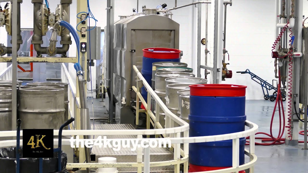 4K UHD - Large barrels moving on conveyor belt in industrial room - YouTube
