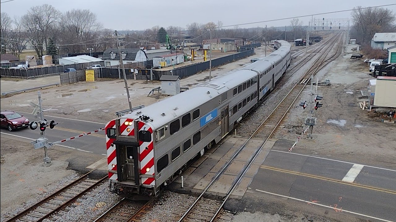 Metra cab-car 8569 east with MP36 411 at Rondout, Illinois on January 2 ...