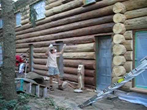 Spraying stain on log home with airless sprayer. - YouTube