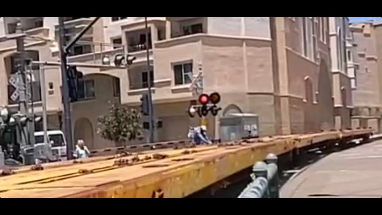 Man attempts to jump and hop on a moving flat car train (Short Version ...
