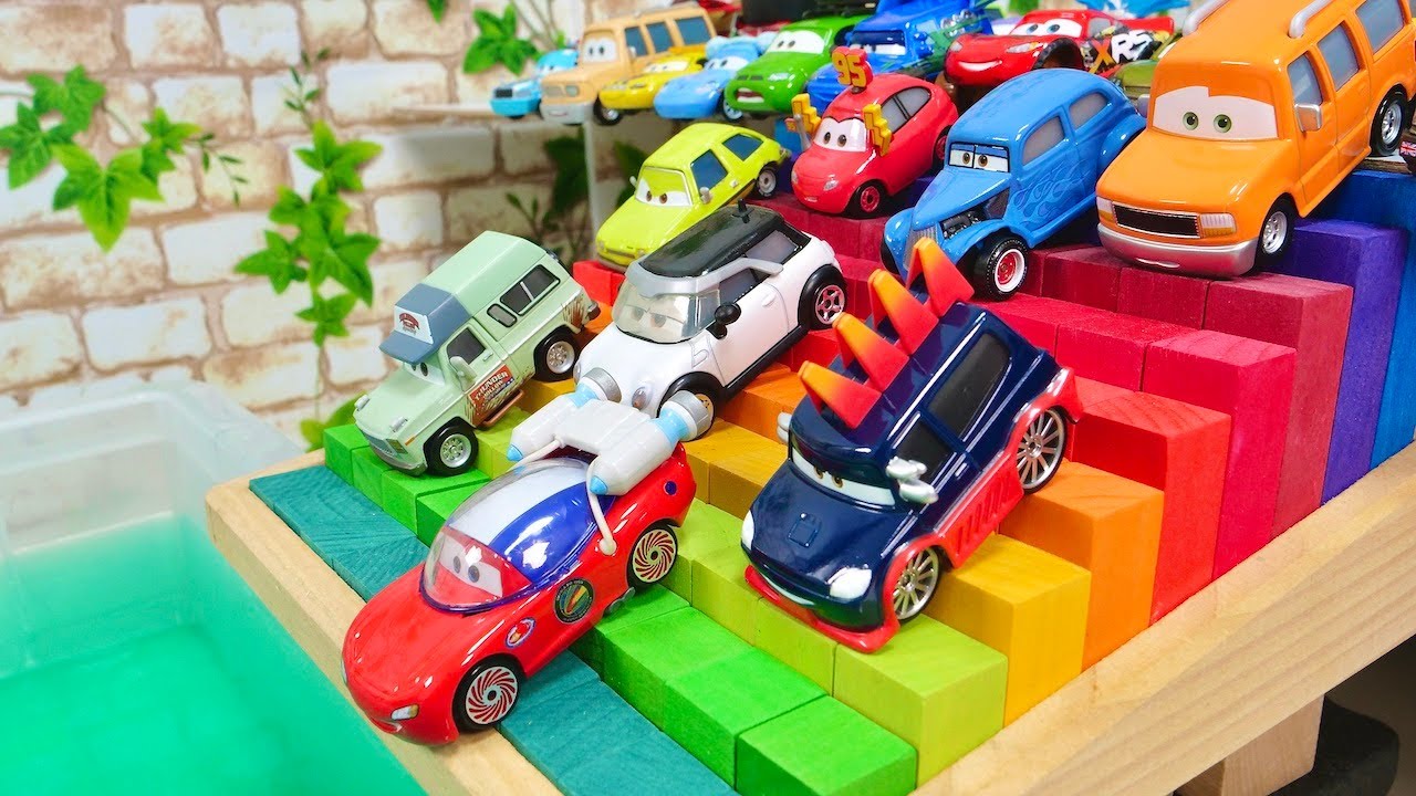 Cars miniature car rolls down colorful rainbow-colored stairs and falls ...