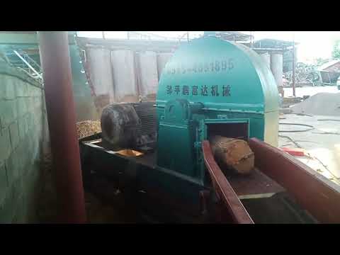 Disc wood chipper process the wood logs - YouTube