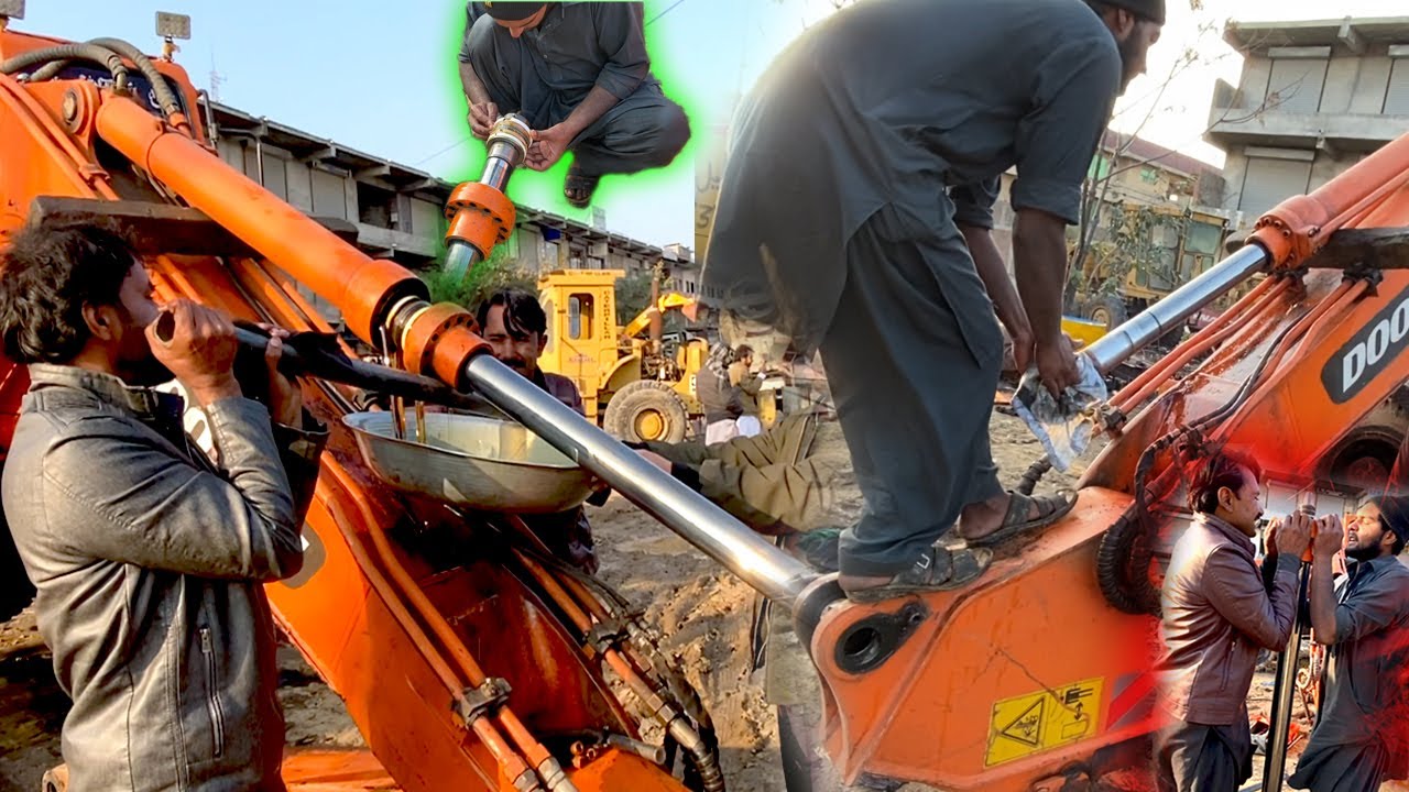 Hardworking mechanics repair Hitachi boom jack leak seal of excavator ...