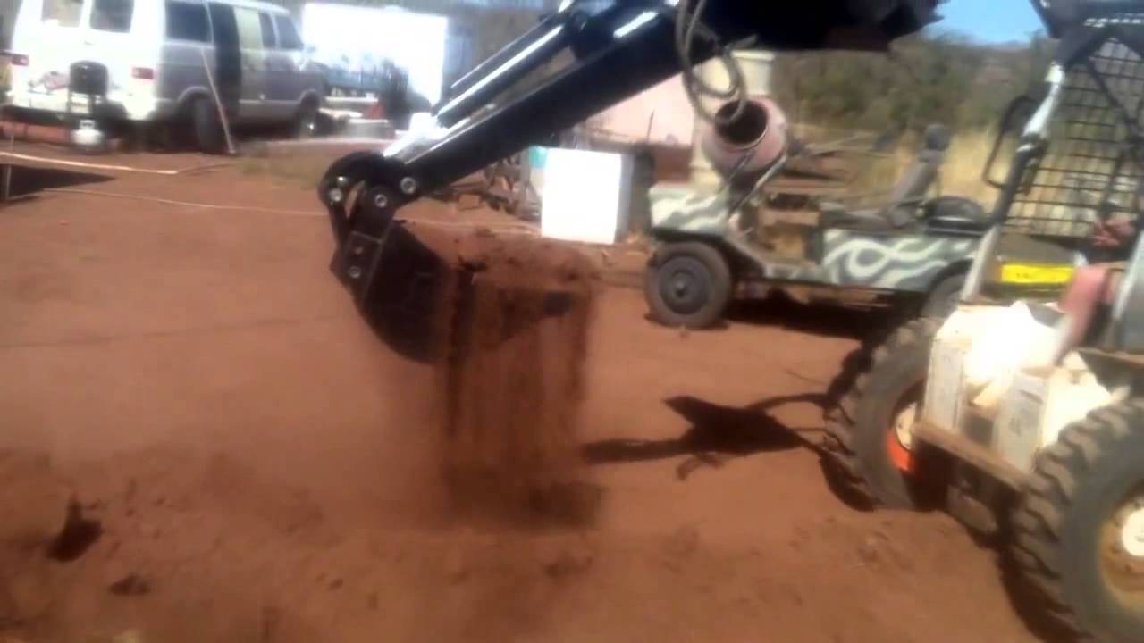 Bobcat Backhoe attachment in action from Titan attachments - YouTube