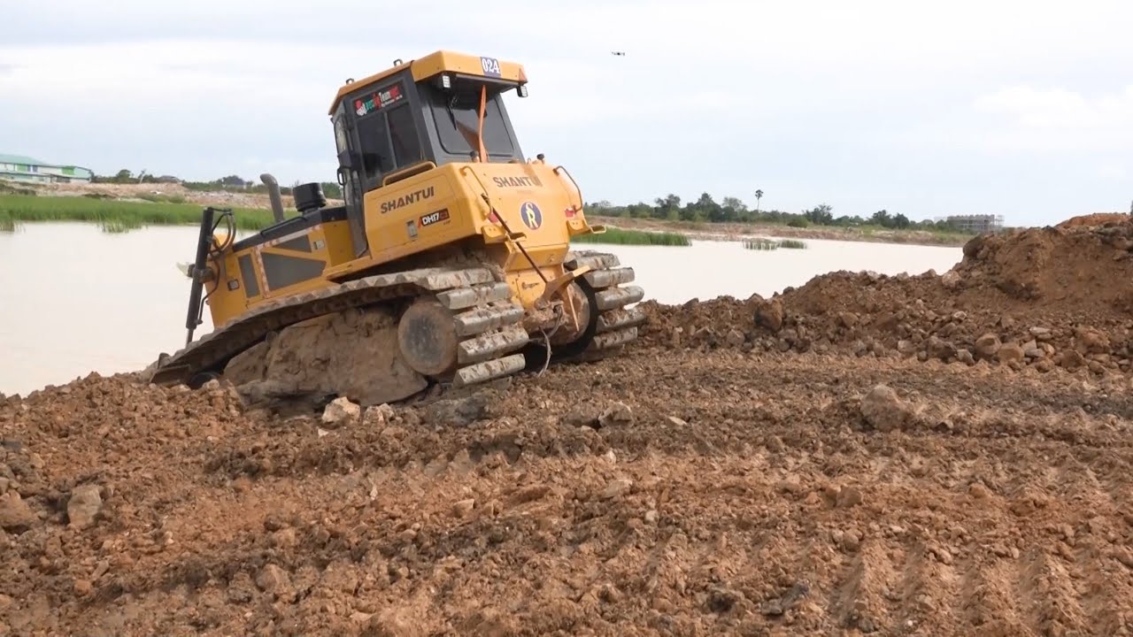 SHANTUI Dozers and Trago Dumper Operating filling up big landscape ...