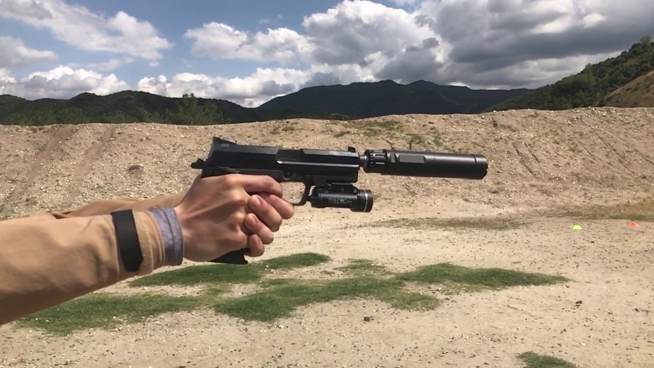 HK USP 45 with sound suppressors slow motion - YouTube