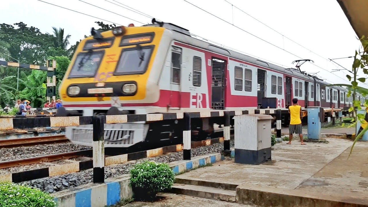 The icf medha emu local train enters the level crossing and proceeds to ...