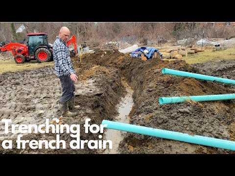 Digging a trench with my compact tractor backhoe to fix backyard ...
