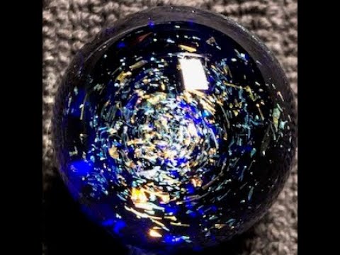 Dichroic rod of glass used to create a marble with a swirlie backing ...