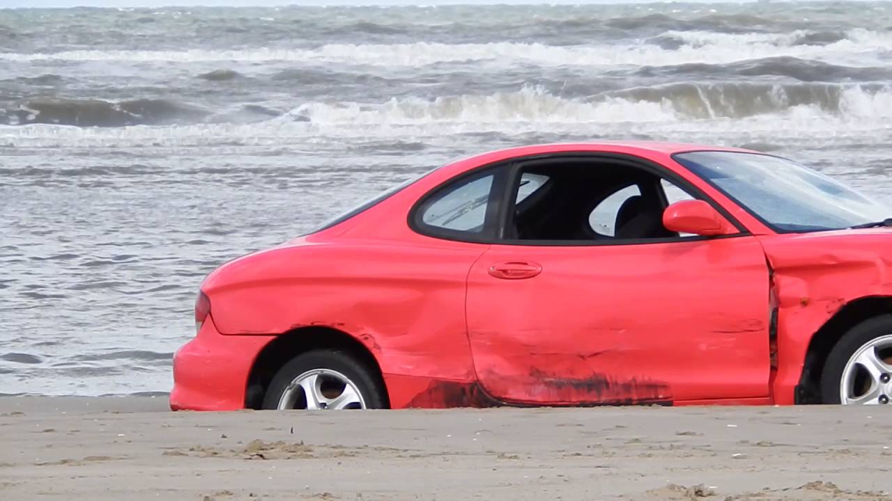 Wrecked and stranded red car on Ainsdale beach - YouTube