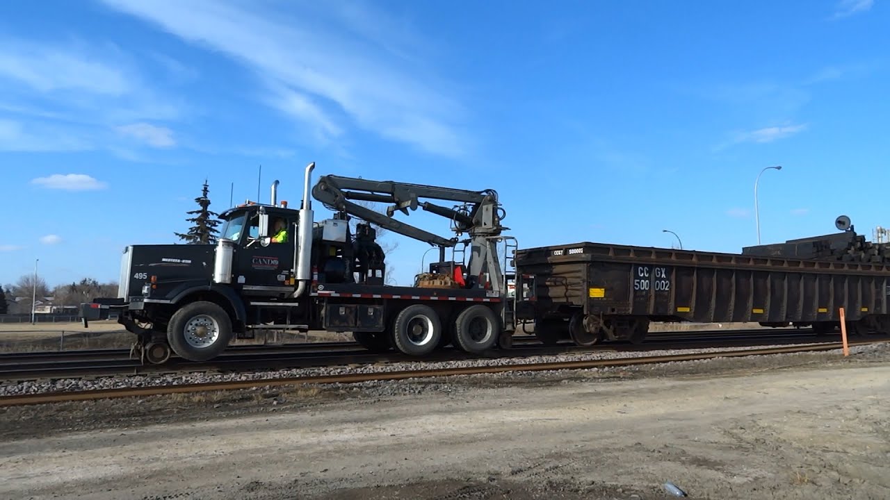 Cando Truck Hauls Gondola and Flats Filled with Ties and Excavator ...