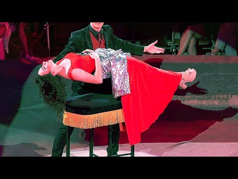 Circus. Magician and lady in red.