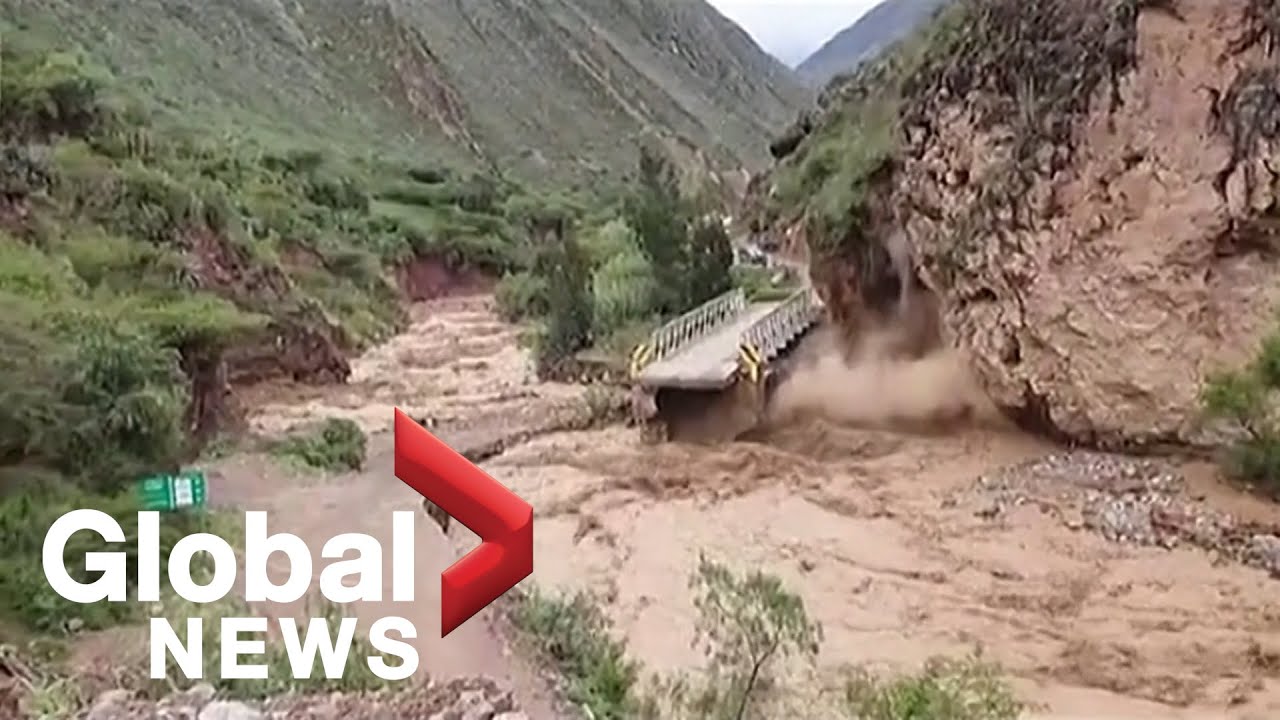 Dramatic video catches hillside collapse on top of bridge amid raging ...