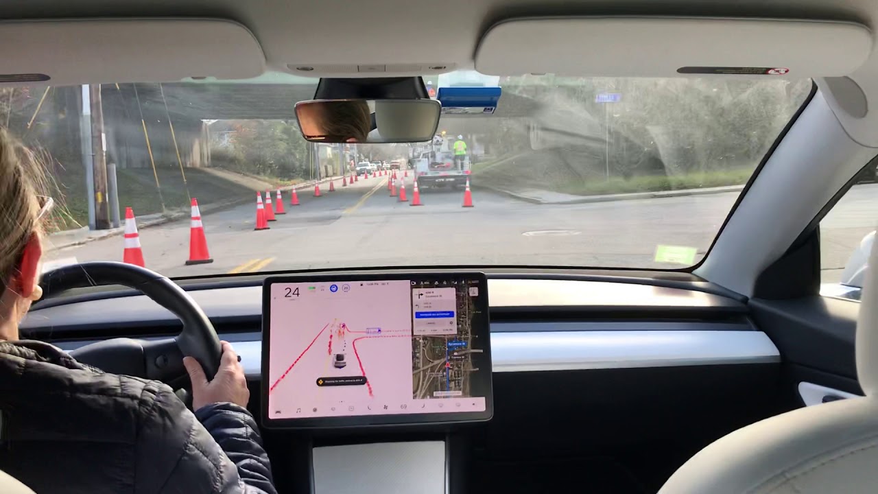 FSD Beta Tesla Model 3 navigating construction zone with cones on both ...