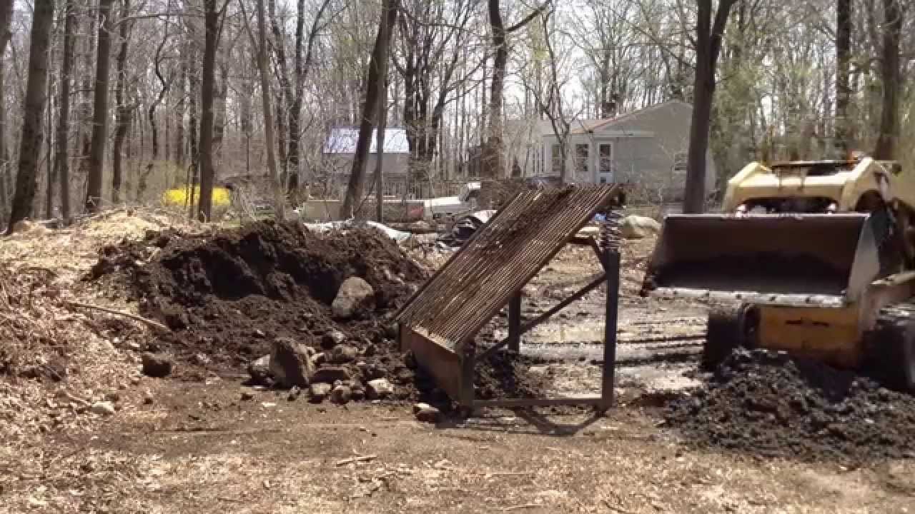 Grizzly bar soil screener working after 2.5" of rain just ended. - YouTube